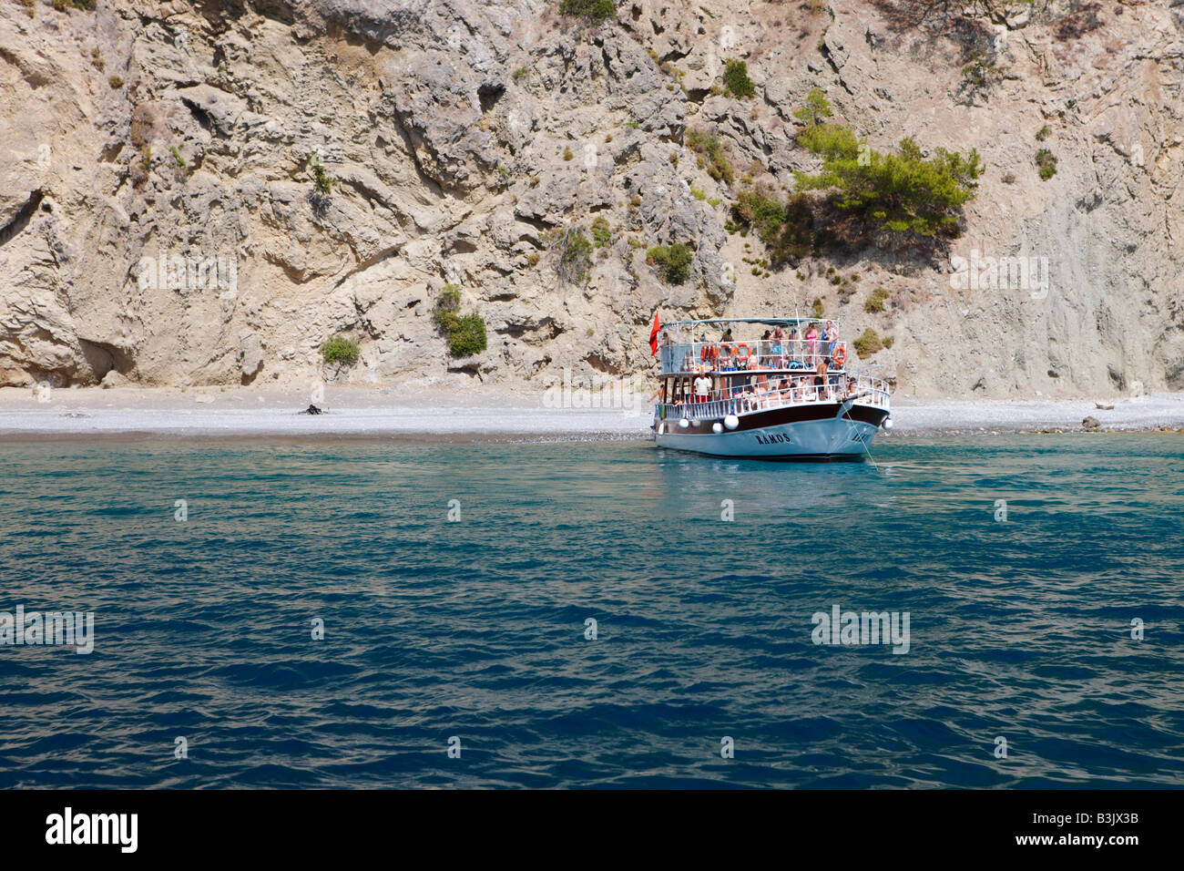 A cruise boat moored at the Camel Beach near Oludeniz, Province of ...