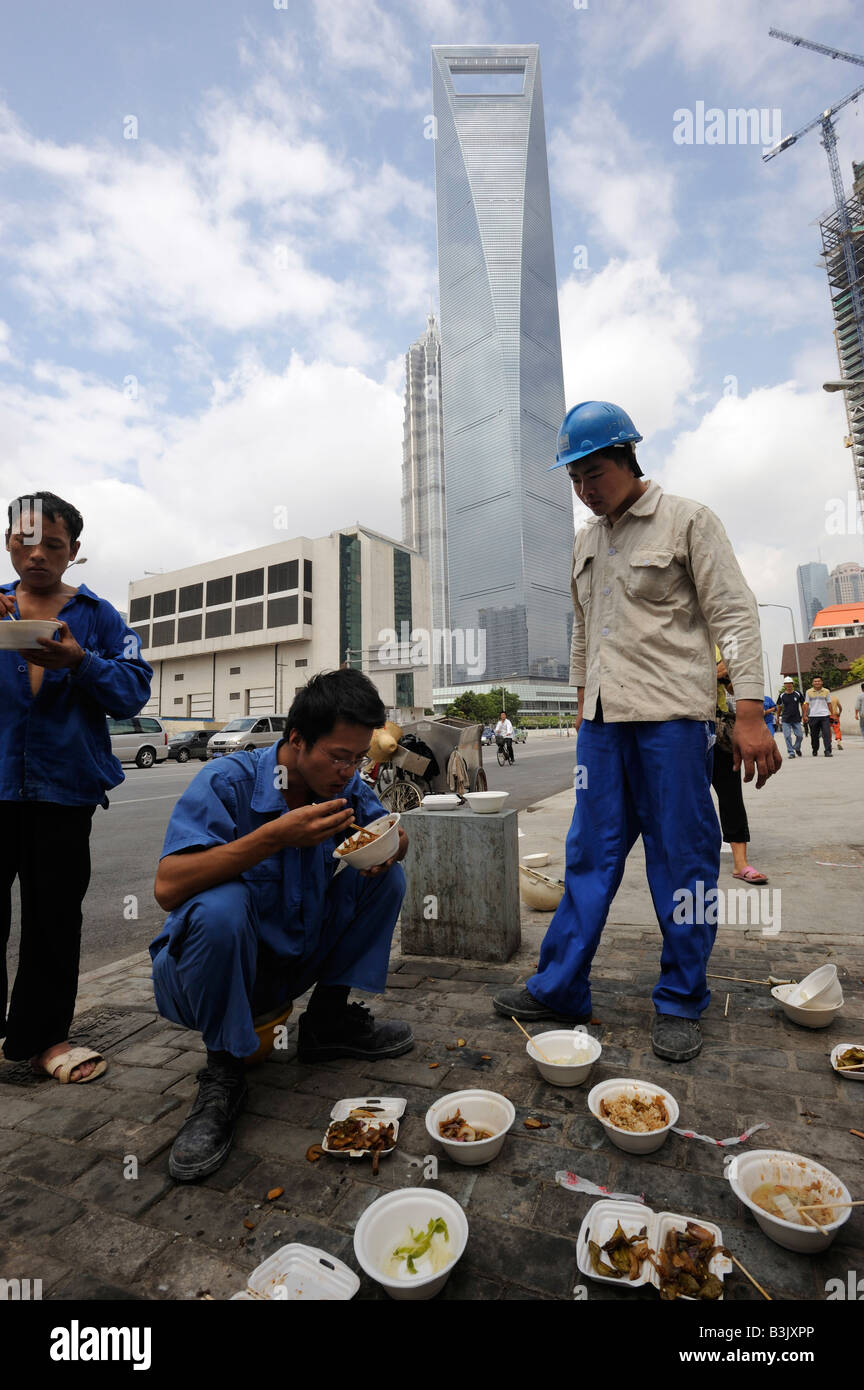 Chinese workers have lunch in front of Shanghai World Financial Center ...