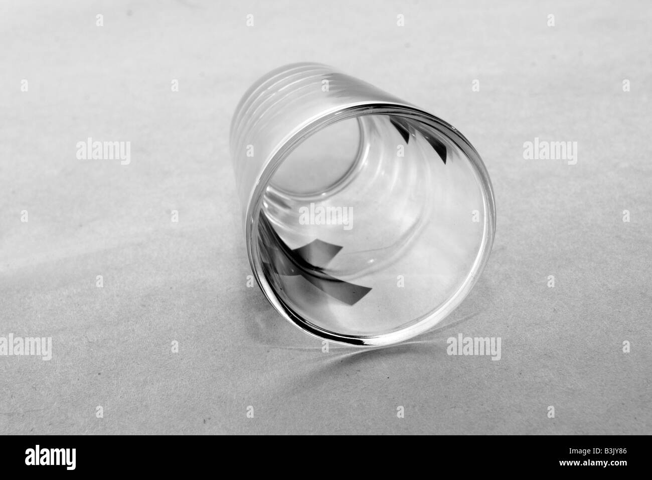 Laying on its side a clear shotglass with two black X markings Stock ...