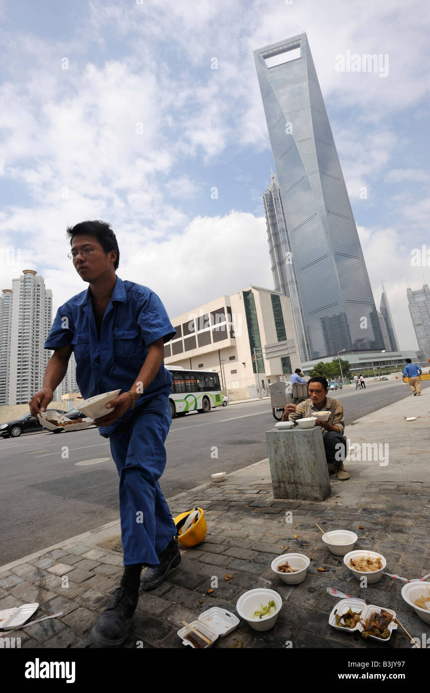 Chinese workers have lunch in front of Shanghai World Financial Center ...