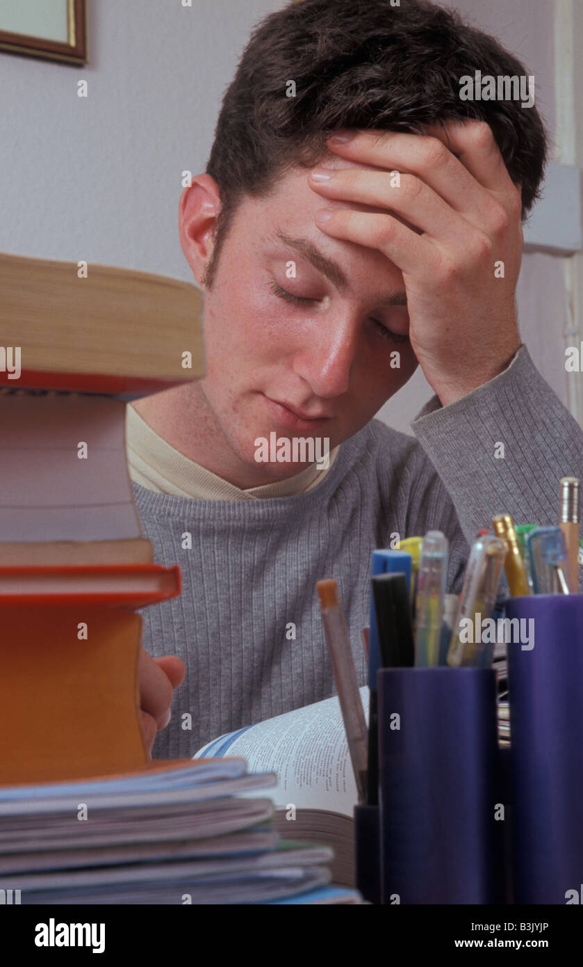 stressed teenage boy doing piles of homework Stock Photo - Alamy