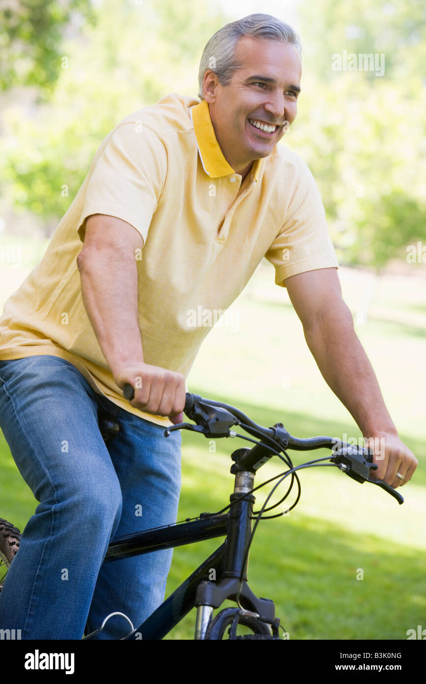 Man on bike outdoors smiling Stock Photo - Alamy