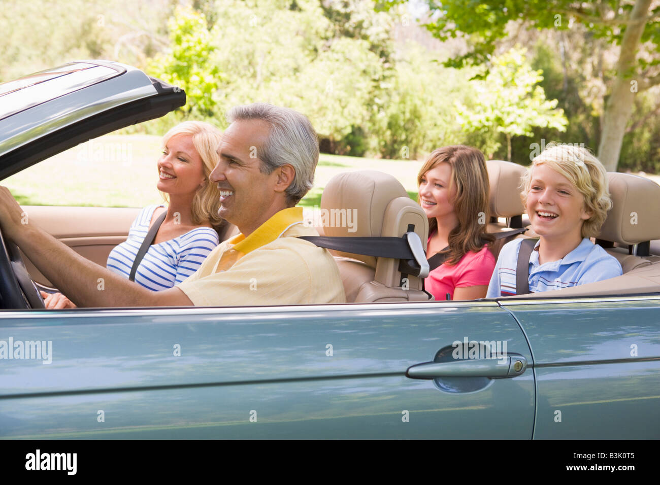Family in convertible car smiling Stock Photo - Alamy