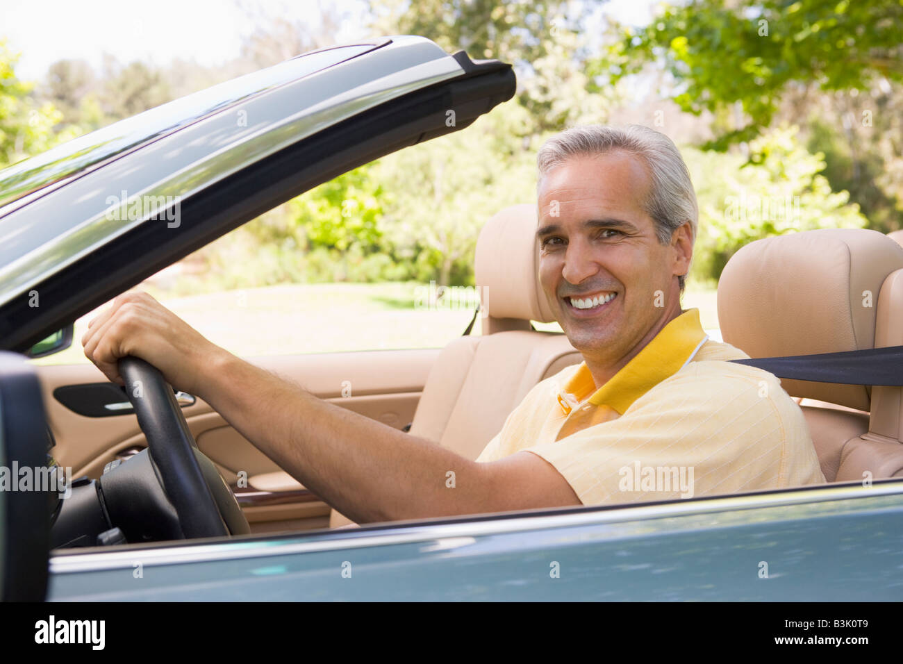 Man in convertible car smiling Stock Photo - Alamy