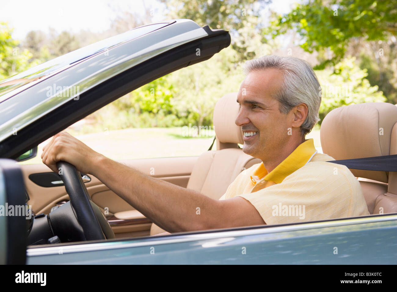Man in convertible car smiling Stock Photo - Alamy