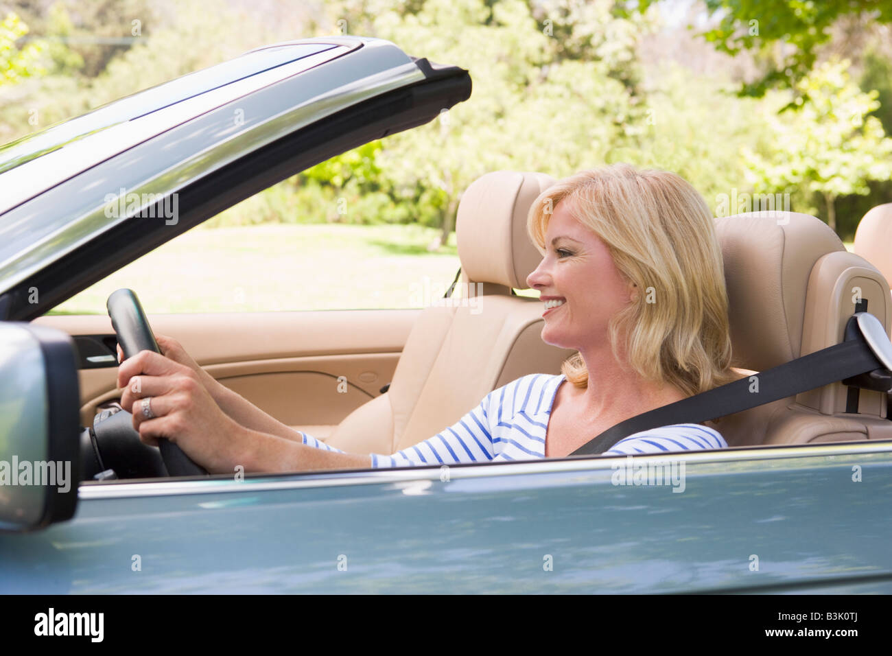 Woman in convertible car smiling Stock Photo - Alamy