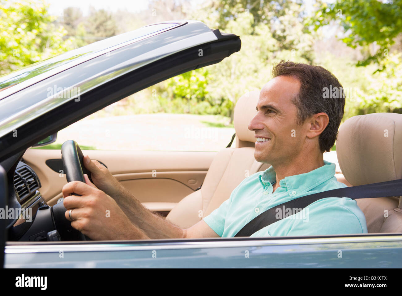 Man in convertible car smiling Stock Photo - Alamy