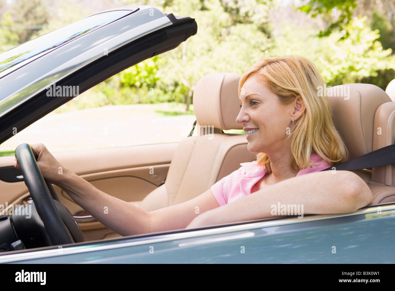 Mature woman driving convertible car hi-res stock photography and ...