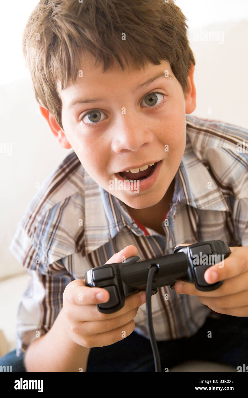 Young boy holding video game controller Stock Photo - Alamy