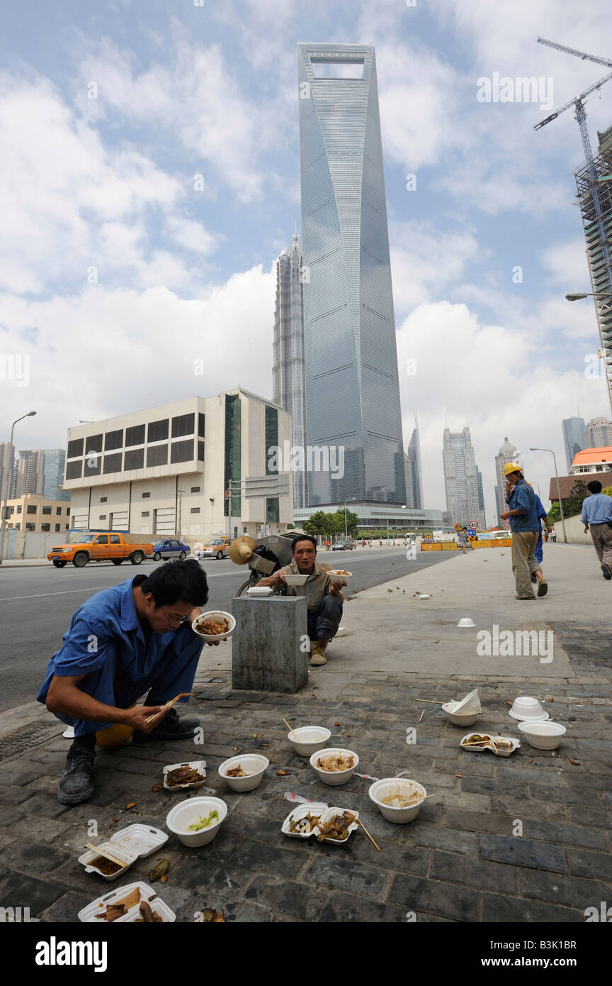 Chinese workers have lunch in front of Shanghai World Financial Center ...