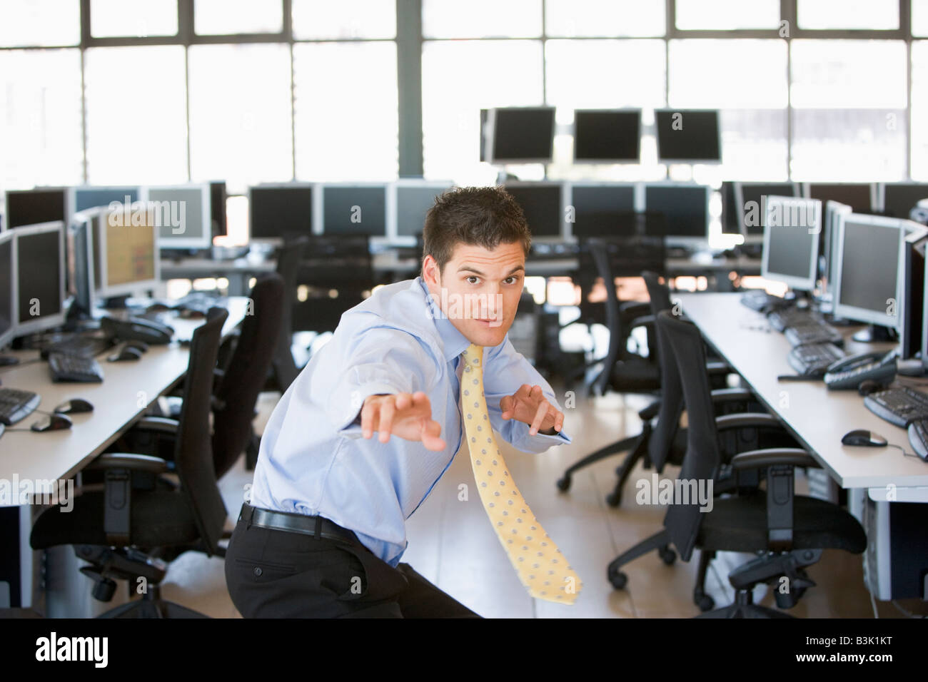 Businessman standing in karate stance in computer room Stock Photo - Alamy