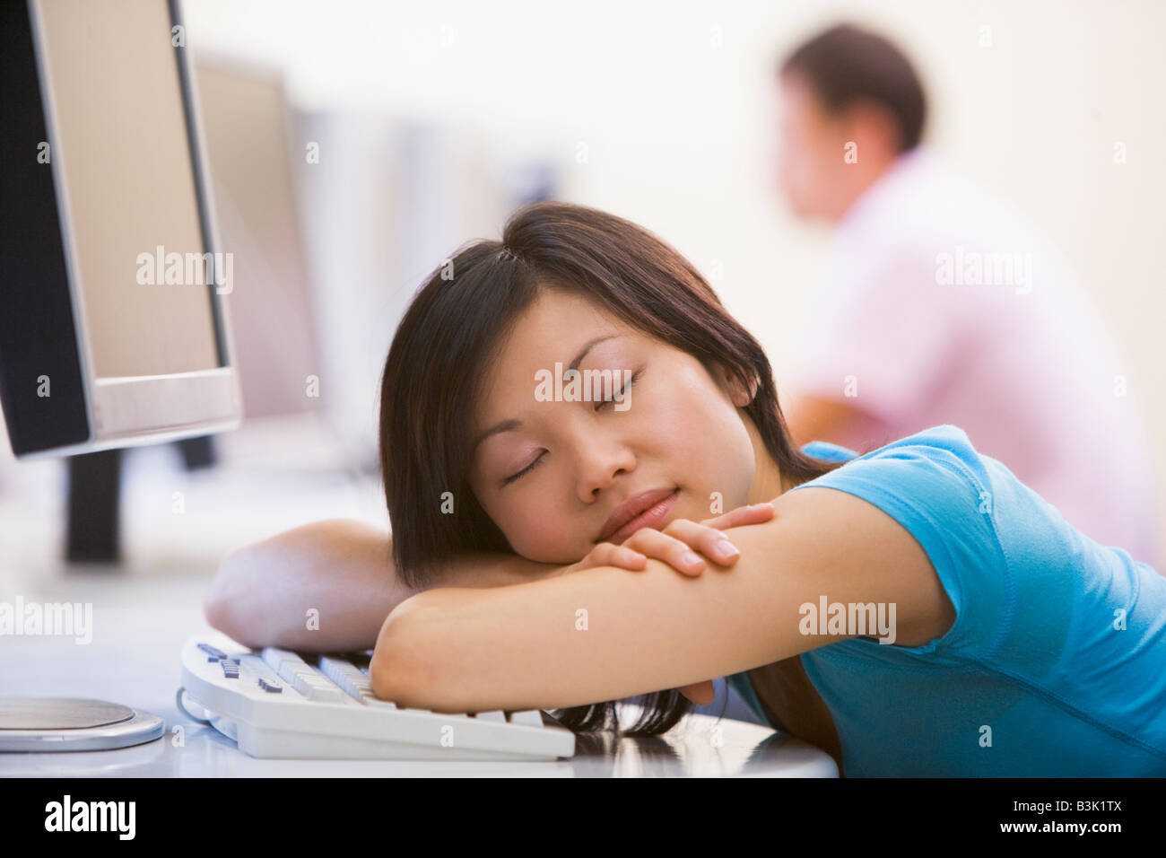 Woman in computer room sleeping Stock Photo - Alamy