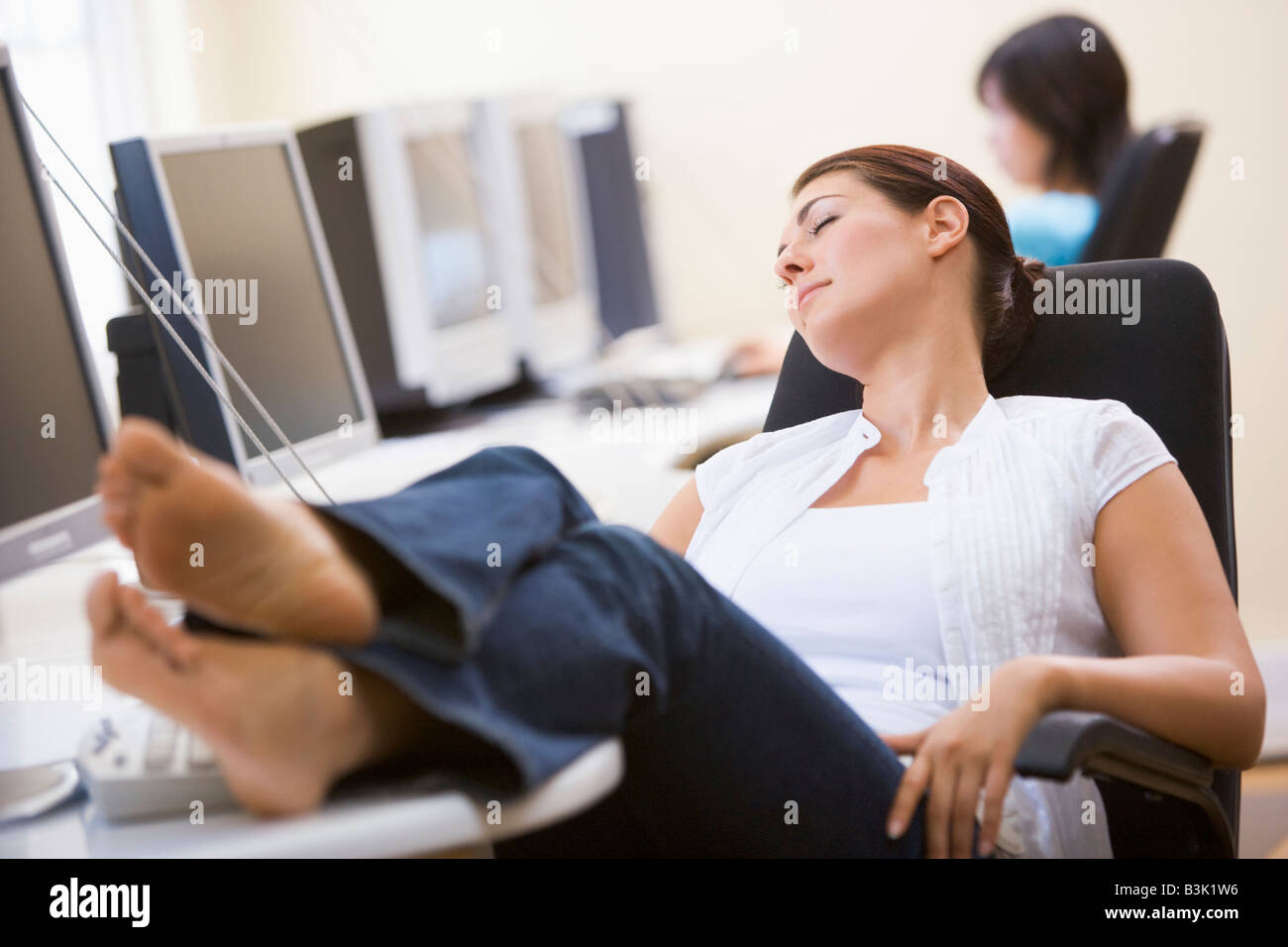 Woman in computer room sleeping Stock Photo - Alamy
