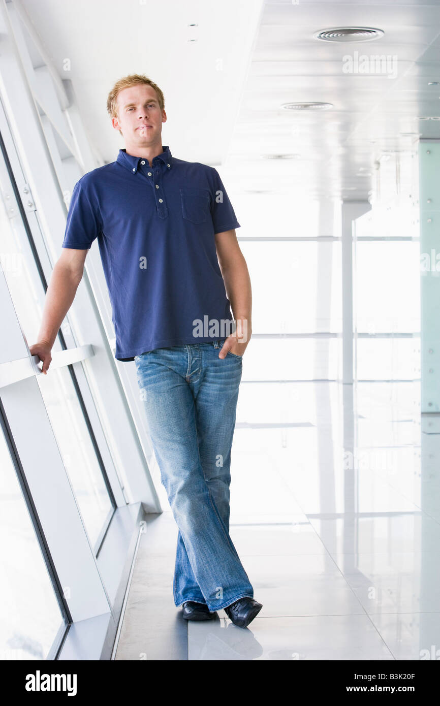 Man standing in corridor Stock Photo - Alamy