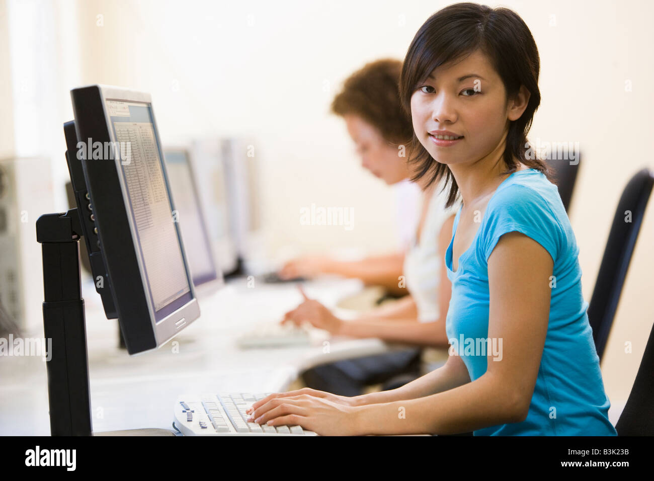 Two women in computer room Stock Photo - Alamy