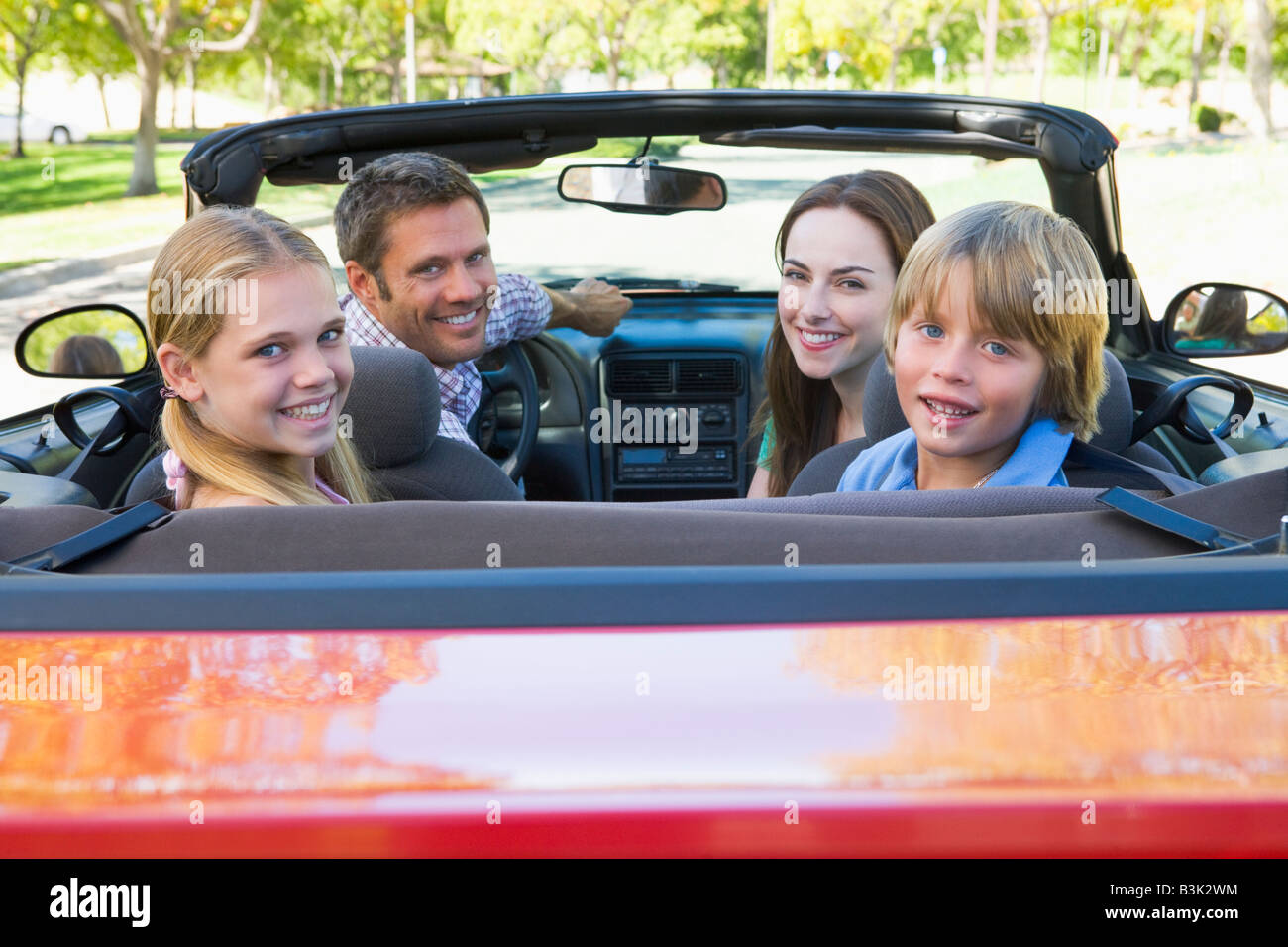 Family in convertible car smiling Stock Photo - Alamy