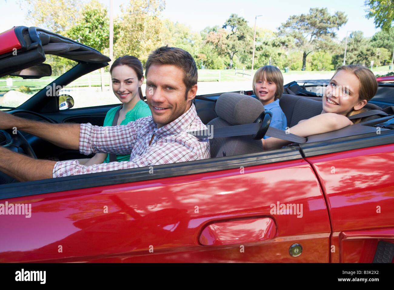 Family in convertible car smiling Stock Photo - Alamy