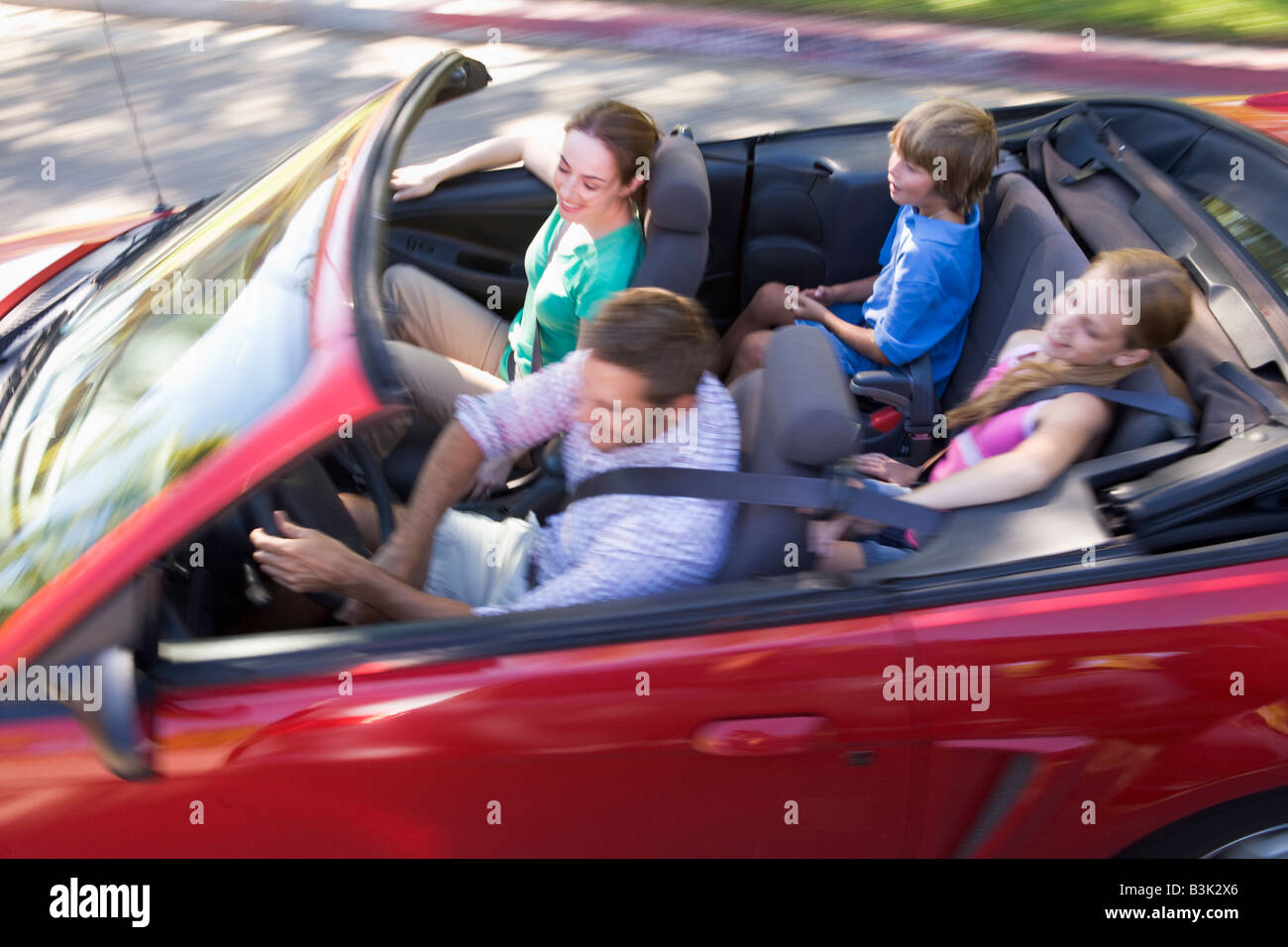Family in convertible car smiling Stock Photo - Alamy