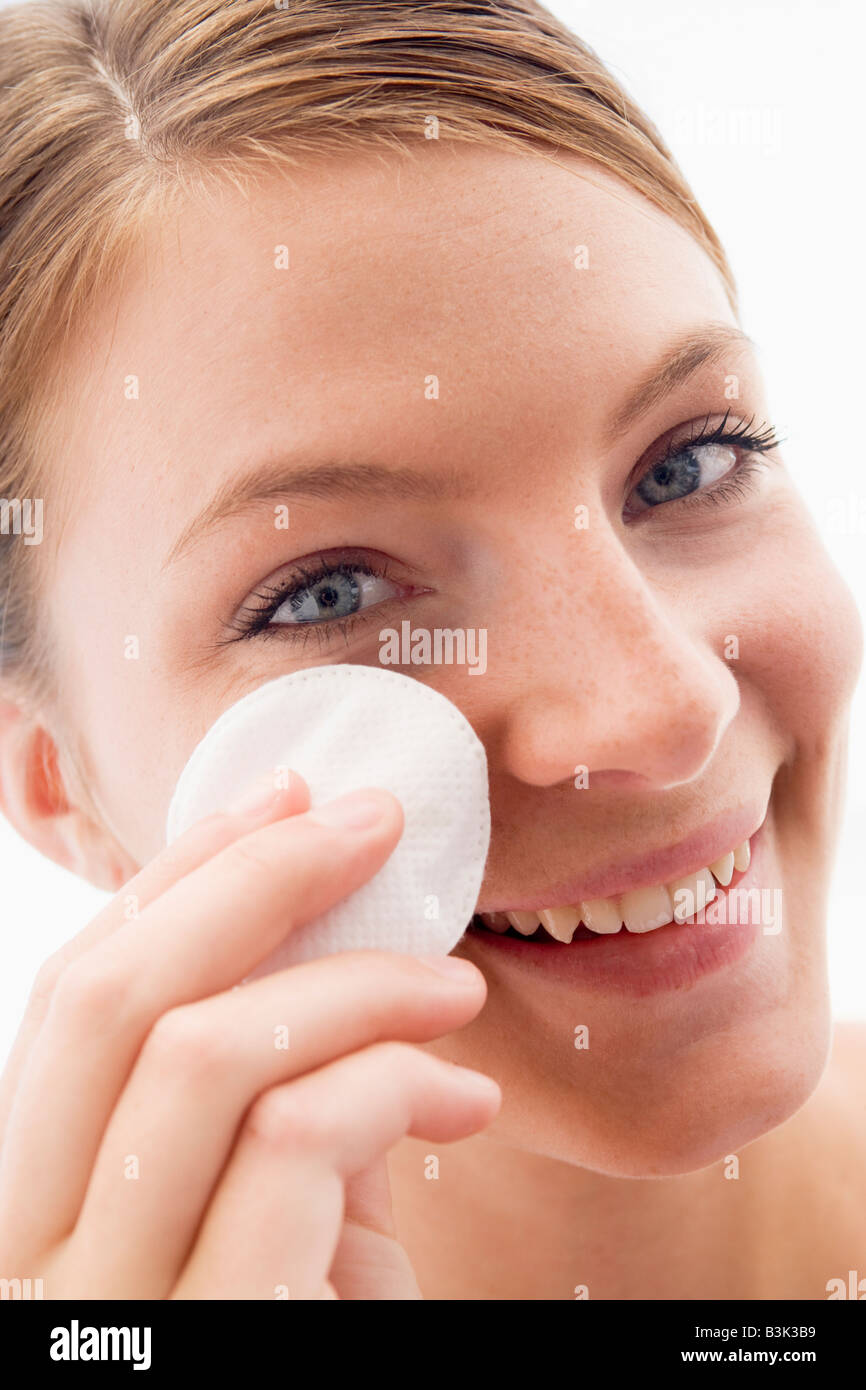 Woman removing makeup and smiling Stock Photo - Alamy