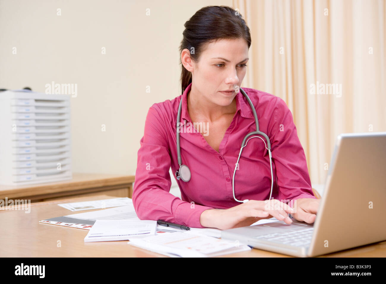 Doctor using laptop in doctor's office Stock Photo - Alamy