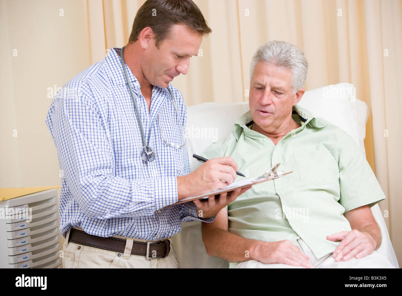 Doctor taking notes on checkup hi-res stock photography and images - Alamy