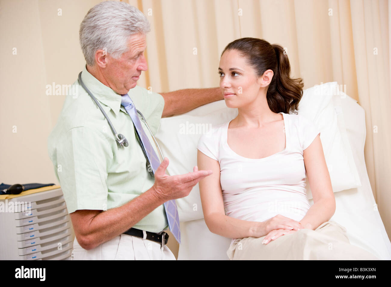 Doctor giving woman checkup in exam room Stock Photo - Alamy
