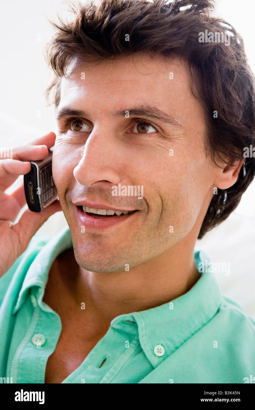 Man using cellular phone and smiling Stock Photo - Alamy