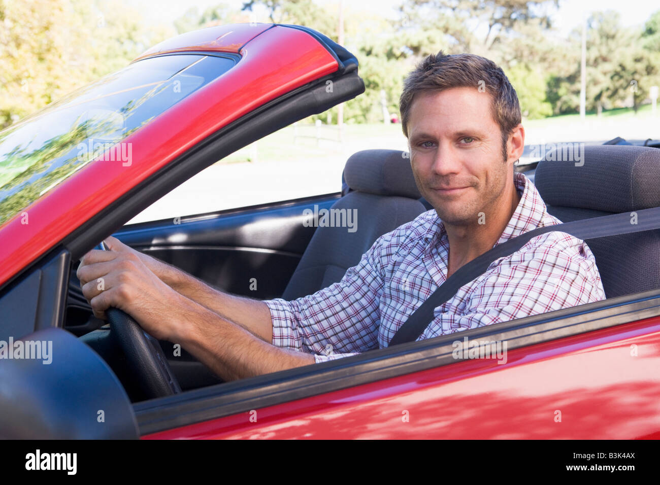 Man in convertible car smiling Stock Photo - Alamy
