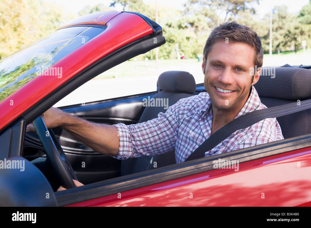 Man in convertible car smiling Stock Photo - Alamy