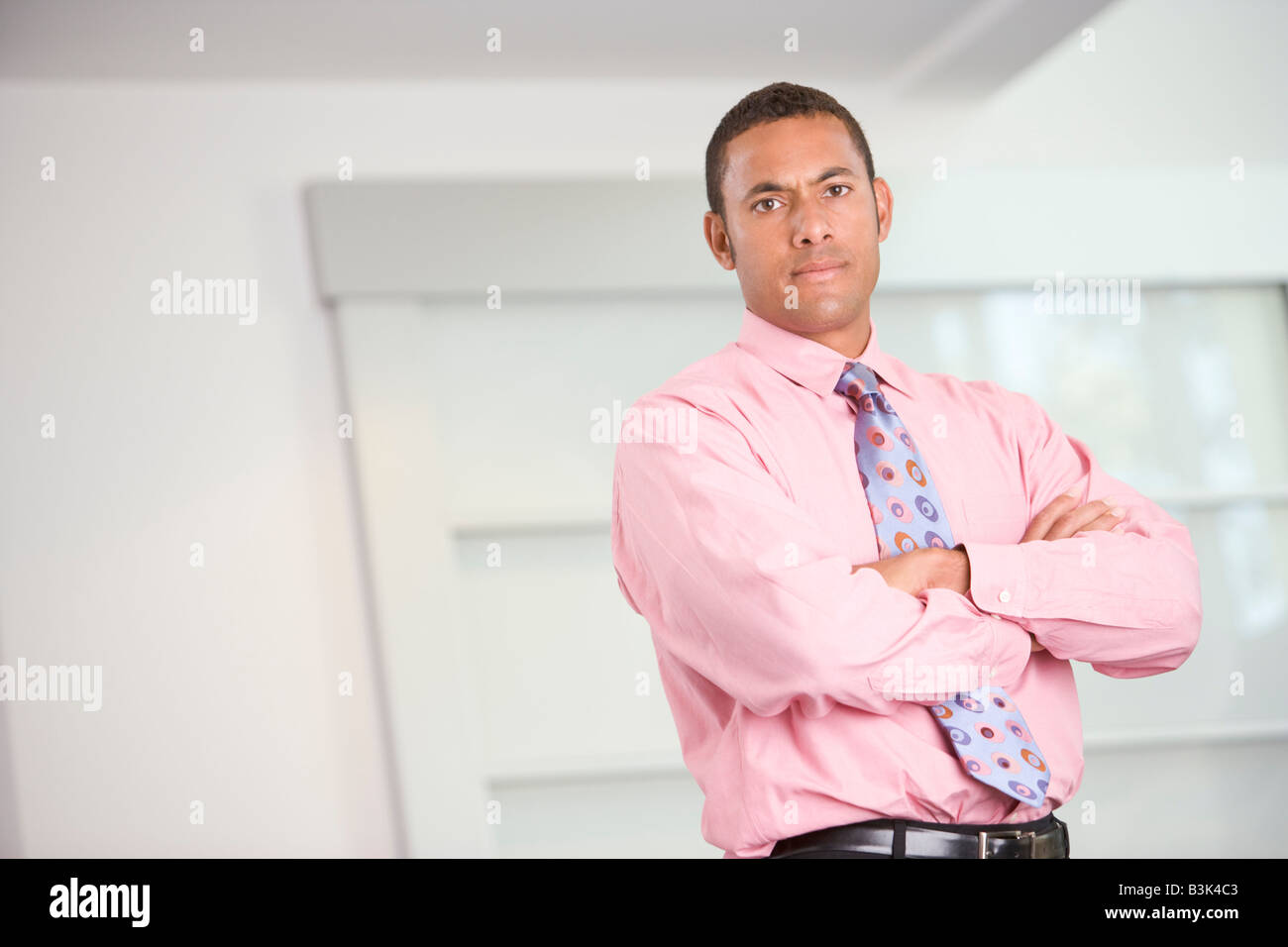 Businessman standing indoors Stock Photo - Alamy