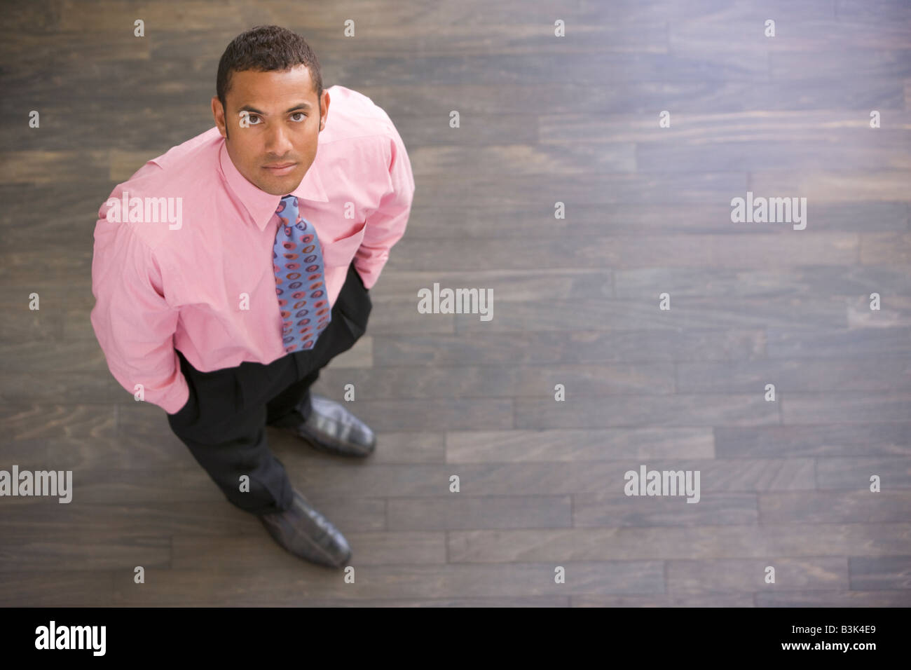 Businessman standing indoors Stock Photo - Alamy