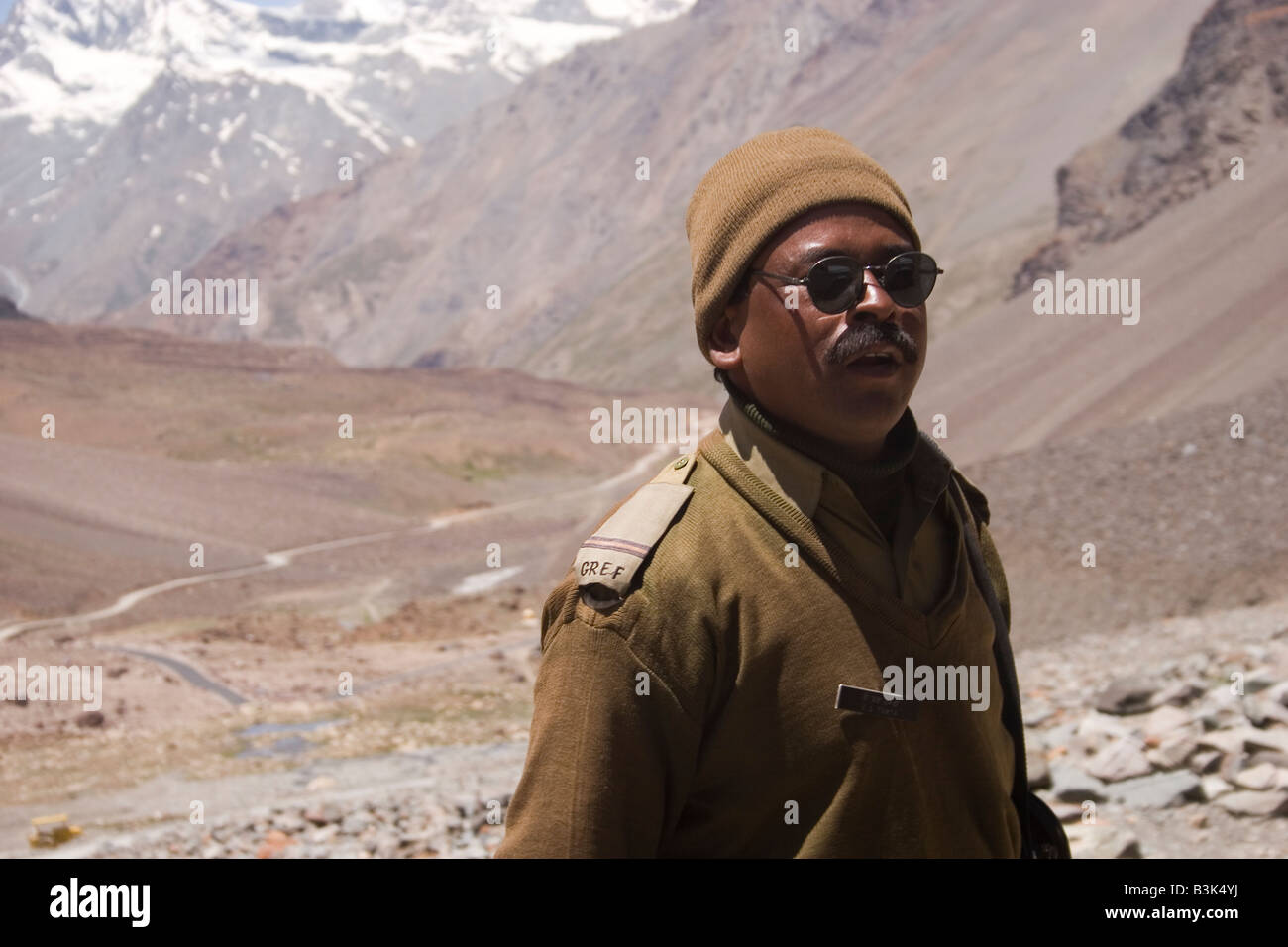 Military local man on road with mountain on background Stock Photo - Alamy