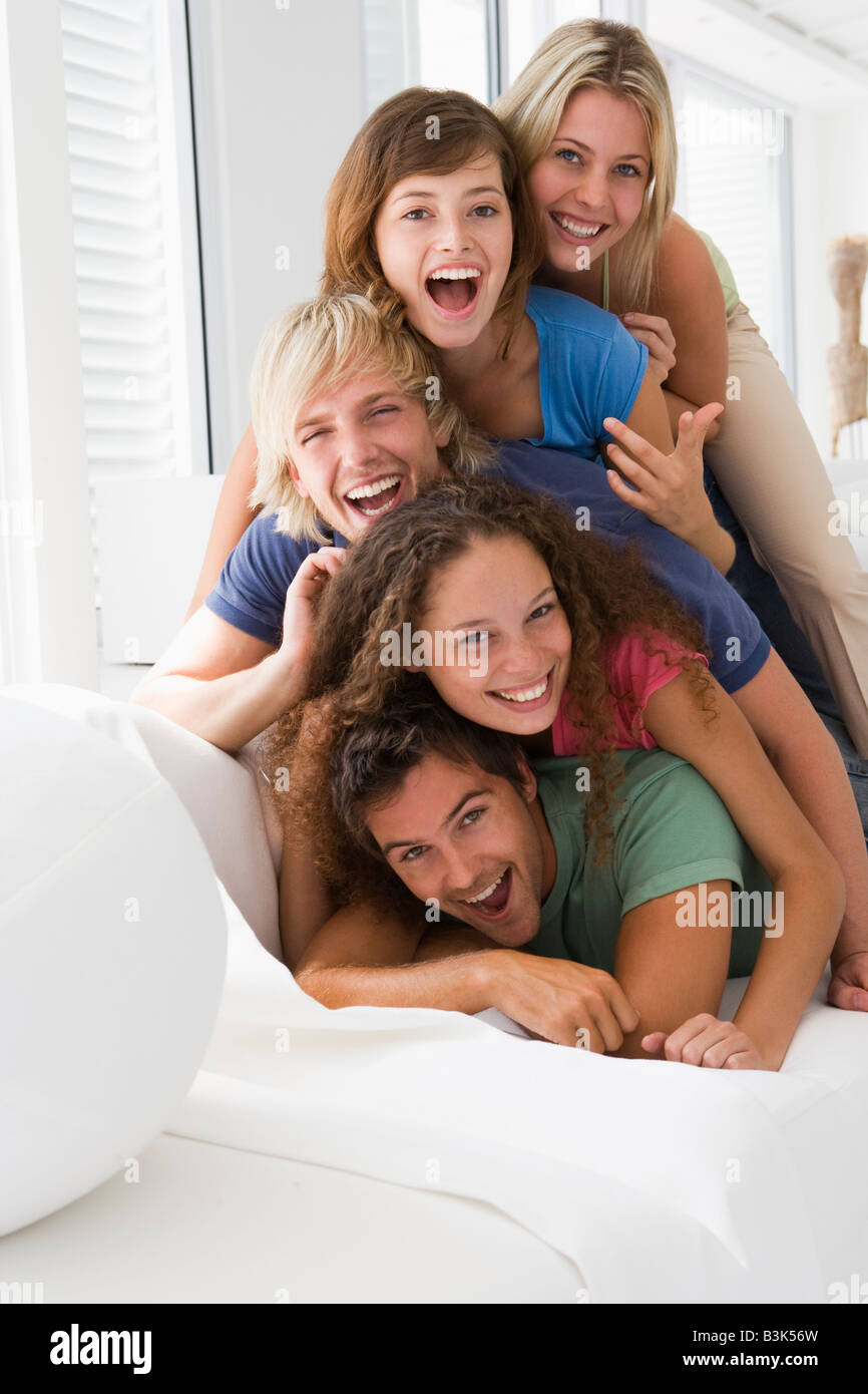 Five people in living room piled up smiling Stock Photo - Alamy