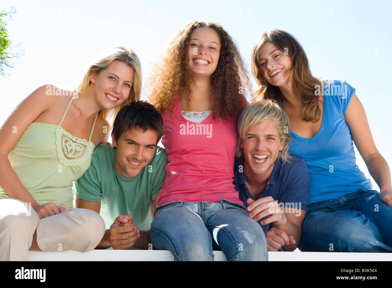 Five people on balcony smiling Stock Photo - Alamy