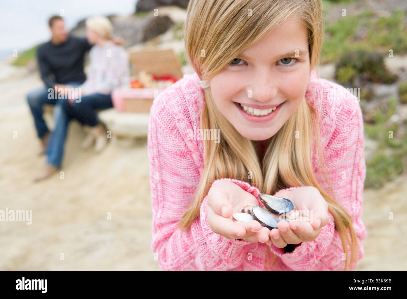 Young family beach collecting shells hi-res stock photography and ...