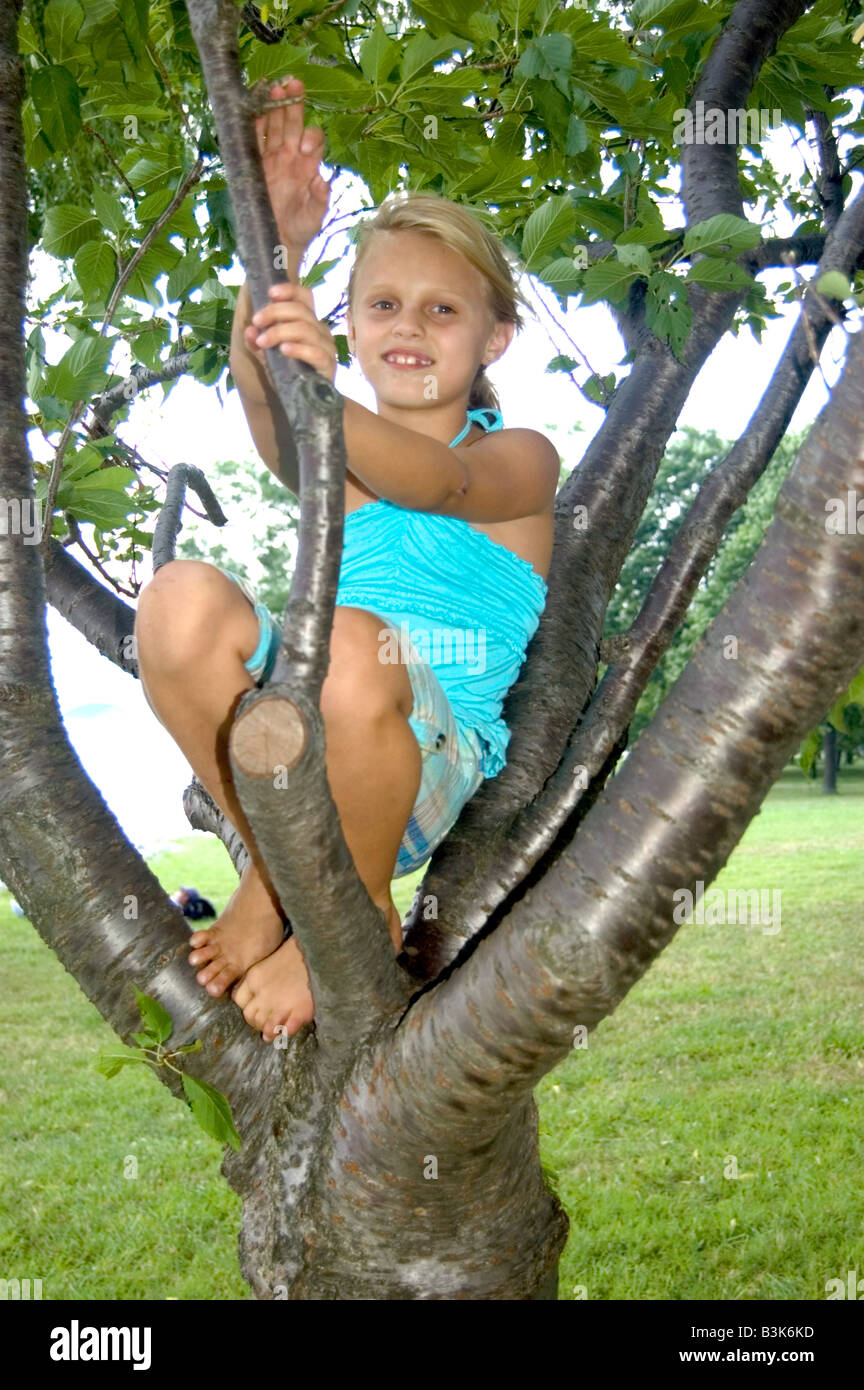 A young girl in a tree Stock Photo - Alamy