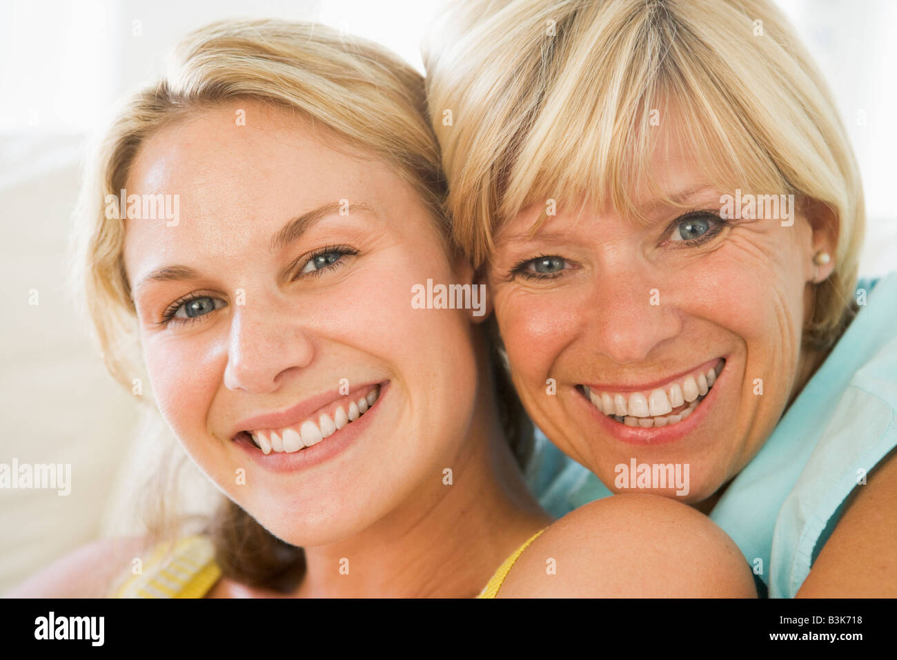 Mother and grown up daughter smiling Stock Photo - Alamy