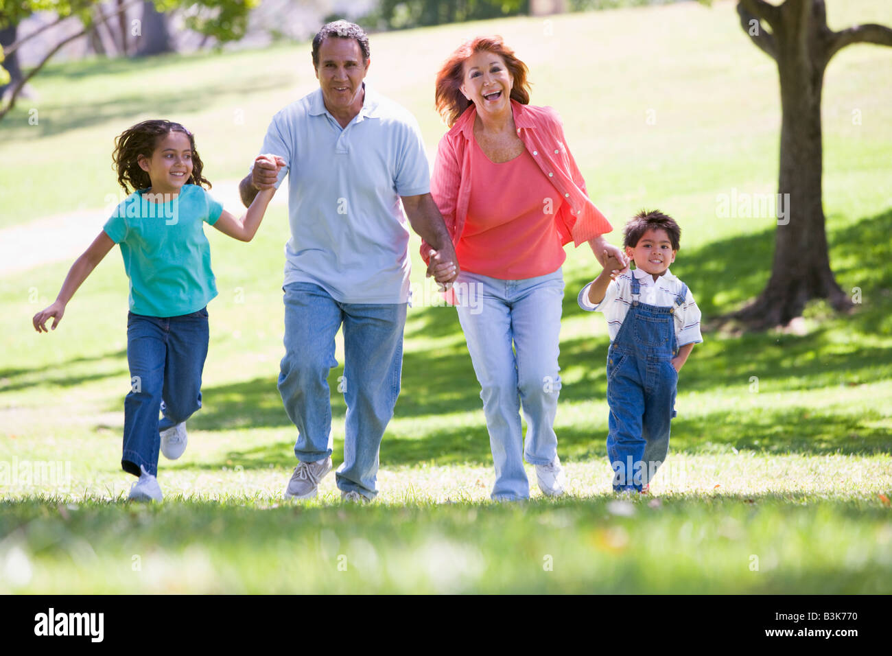 Senior and child running holding hands hi-res stock photography and ...