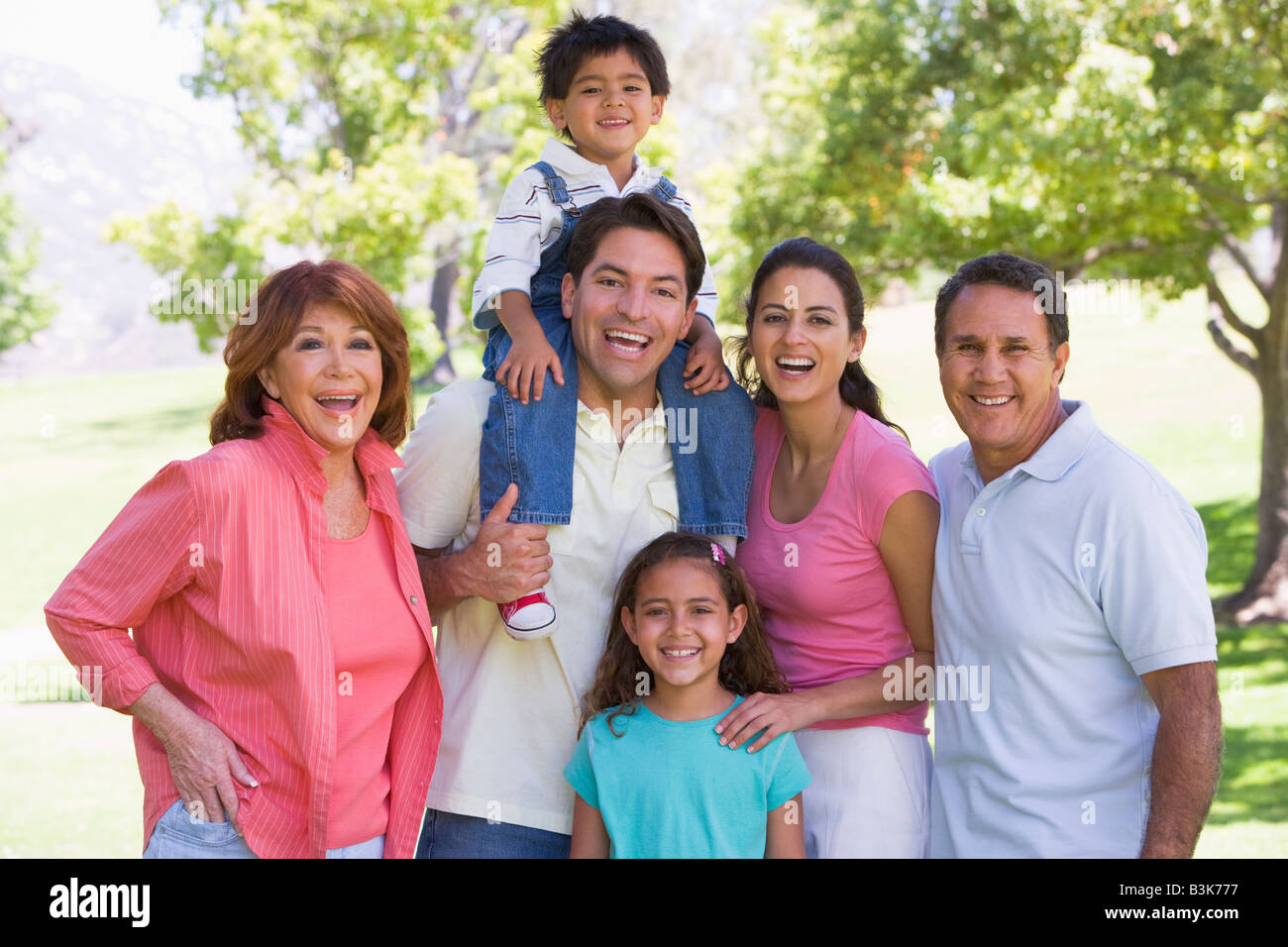 Extended family standing outdoors smiling Stock Photo - Alamy