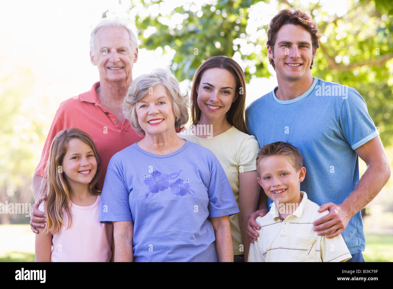 Happy extended family standing park hi-res stock photography and images ...