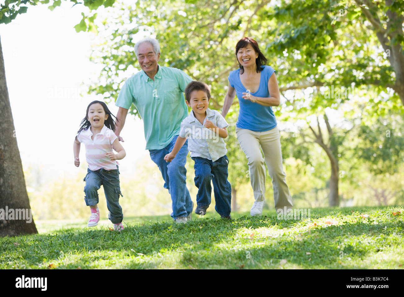 Grandparents running with grandchildren Stock Photo - Alamy