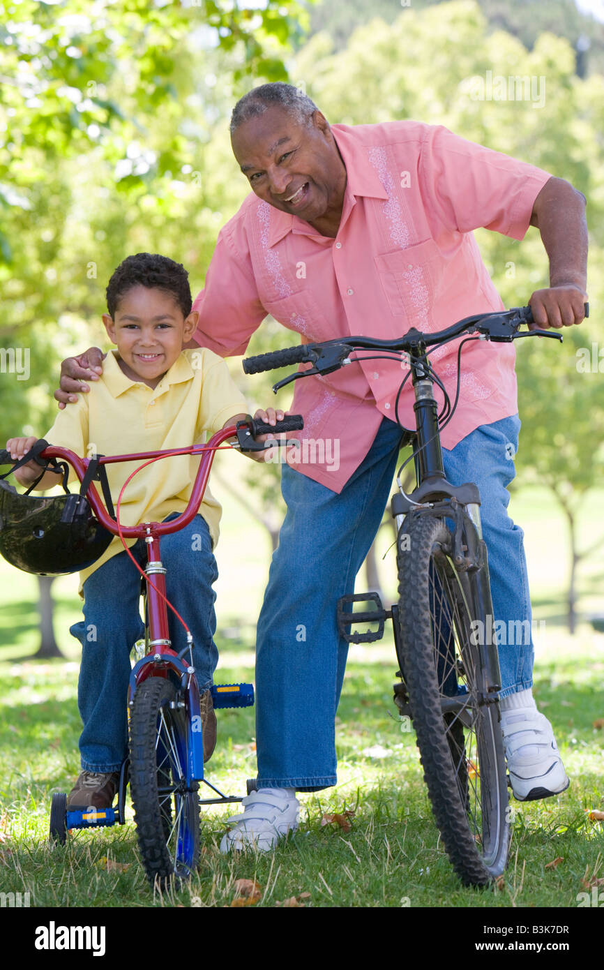 Grandfather and grandson on bikes outdoors smiling Stock Photo - Alamy