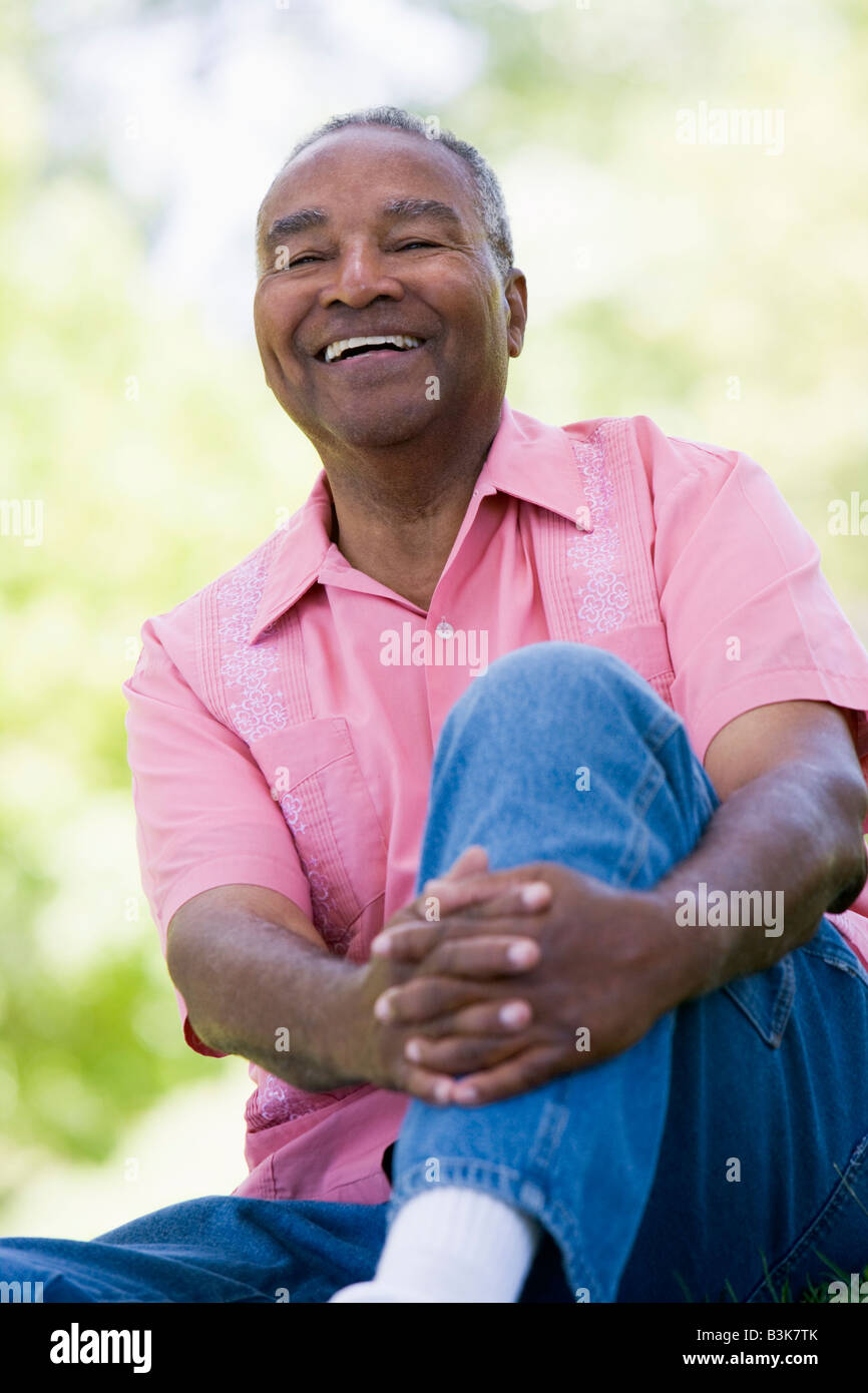 Senior man sitting outdoors Stock Photo - Alamy