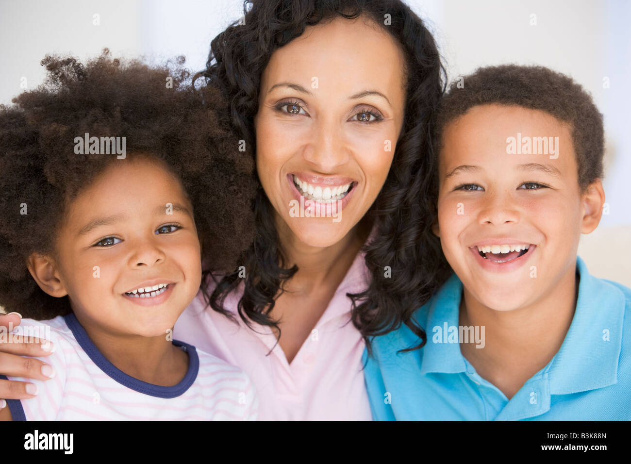 Woman and two young children smiling Stock Photo - Alamy