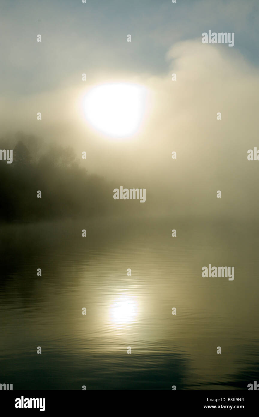 Sunrise in the mist Stock Photo - Alamy
