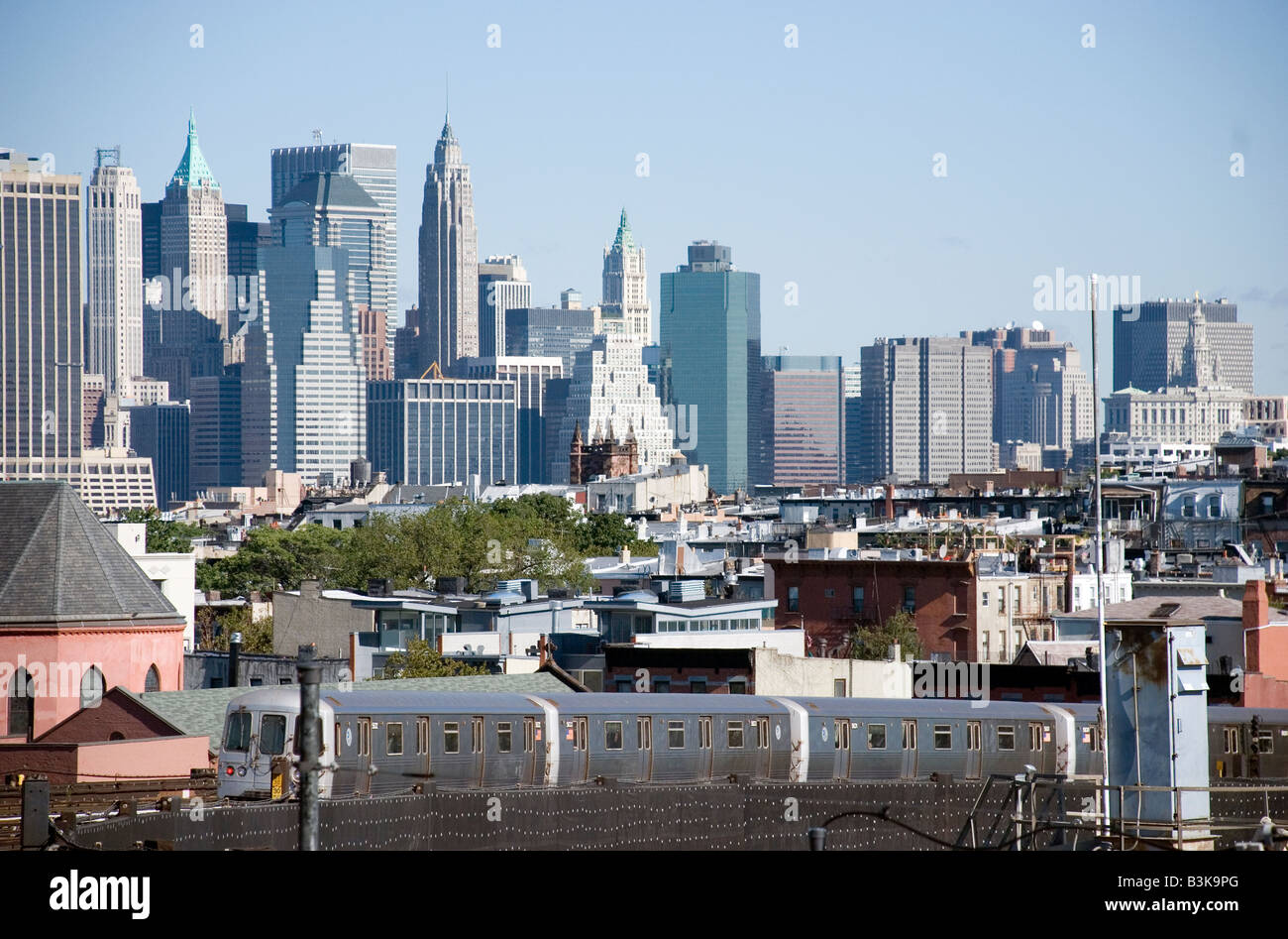 MTA subway train in the foreground with Manhattan skyline in the ...