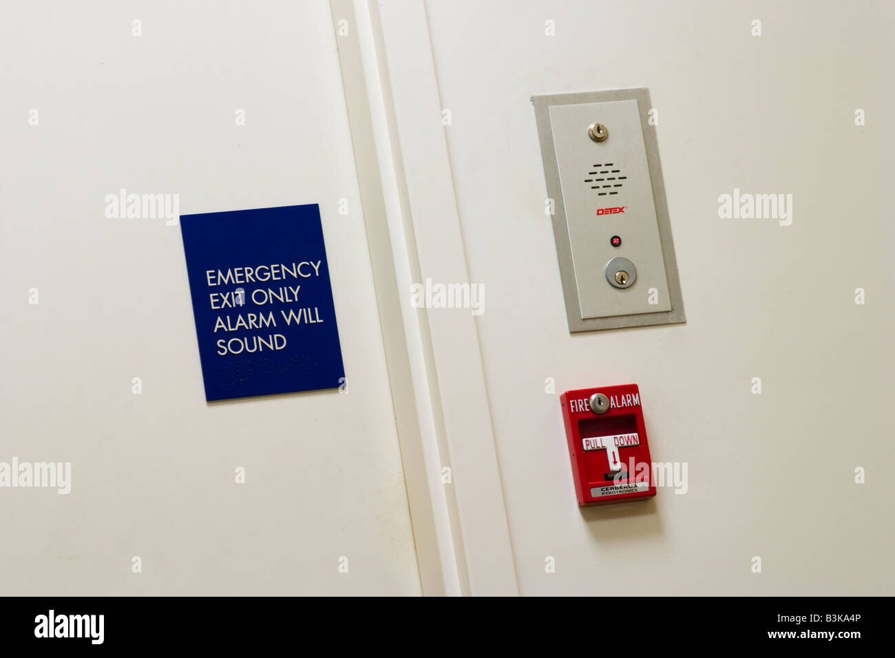 Wall in an office building with an intercom fire alarm and a sign ...