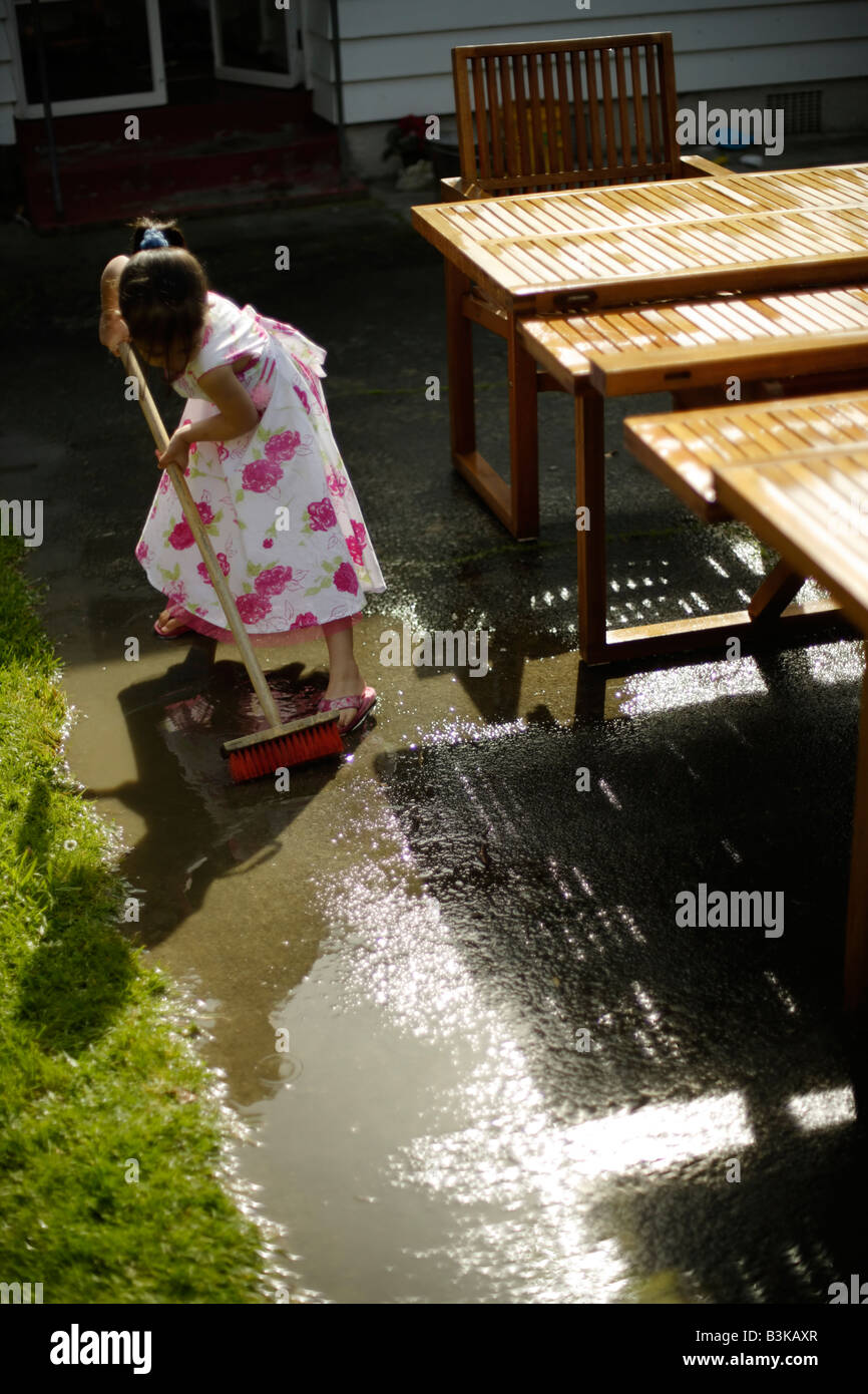 Child sweeping outside hi-res stock photography and images - Alamy