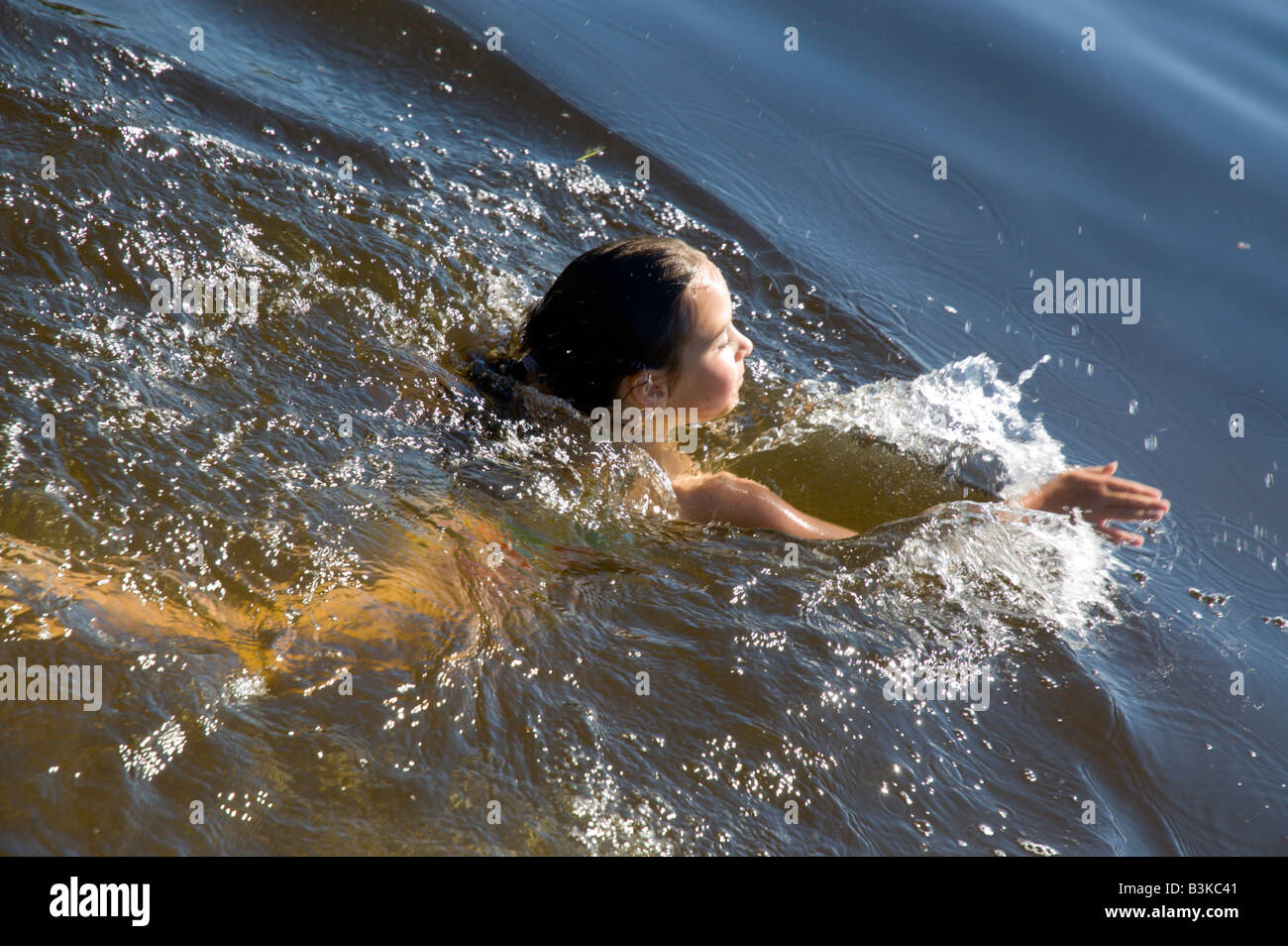 Little girl swimming at the lake Stock Photo - Alamy