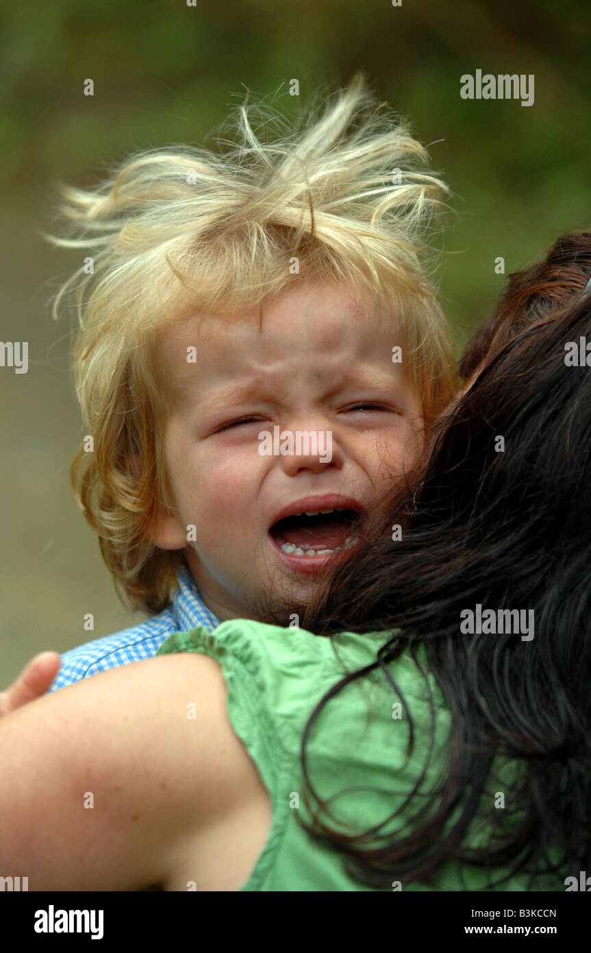 Boy crying, being comforted by his mother Stock Photo - Alamy